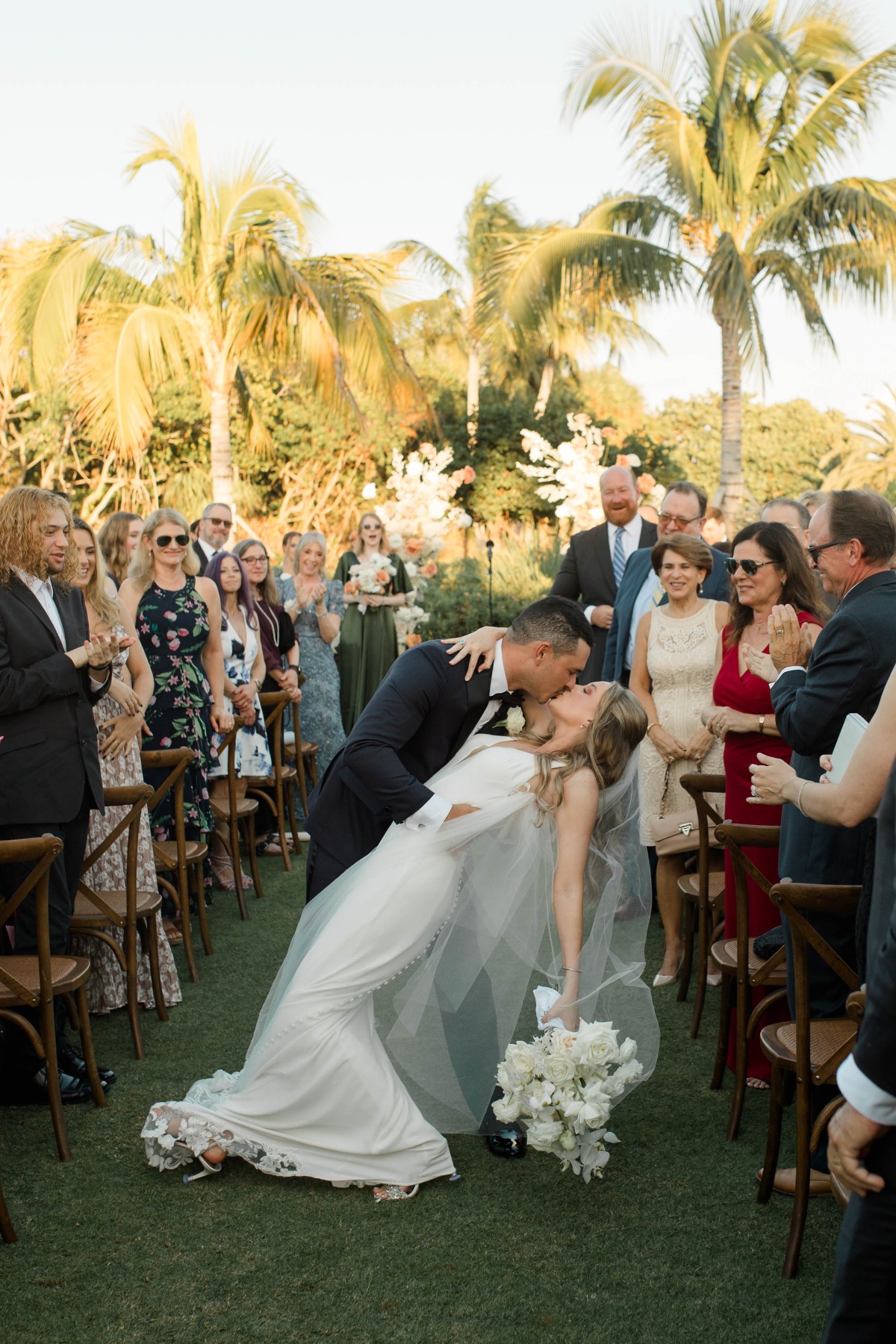 Wedding lit with chandeliers made entirely of trailing peach florals ...